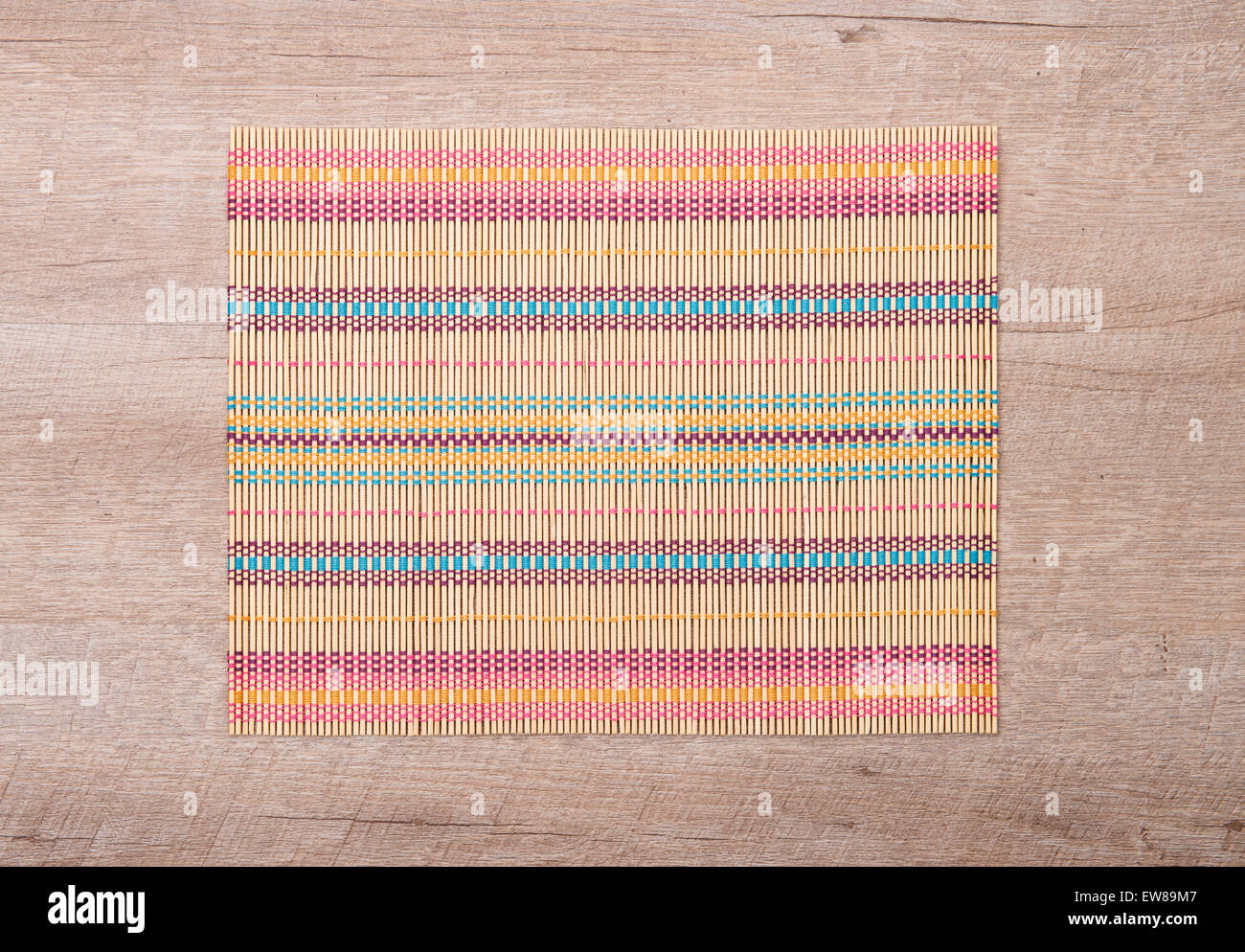 Bamboo place mat on wooden deck table Stock Photo - Alamy