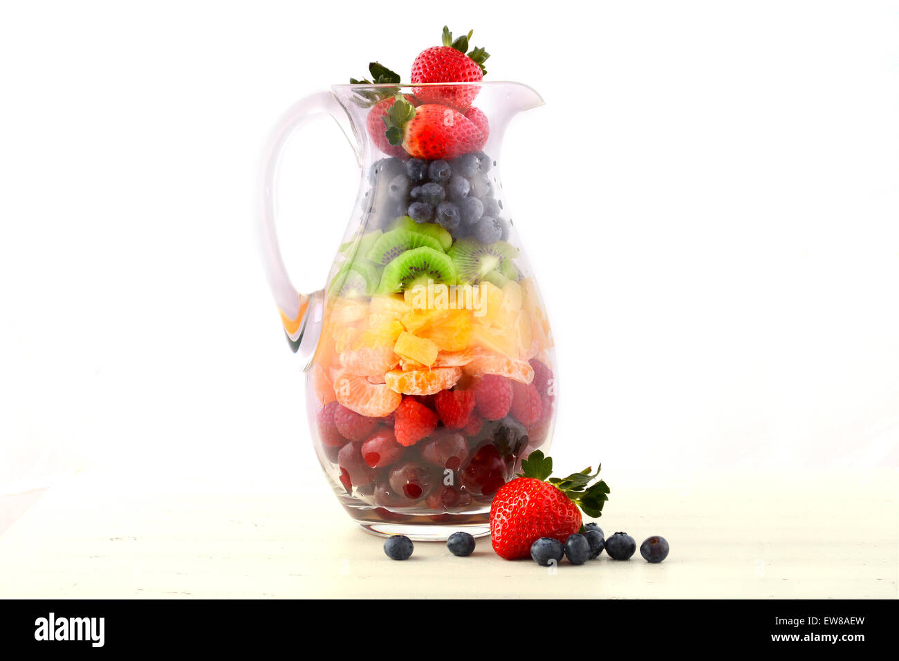Fresh fruit juice concept with rainbow color fruit including cherries ...