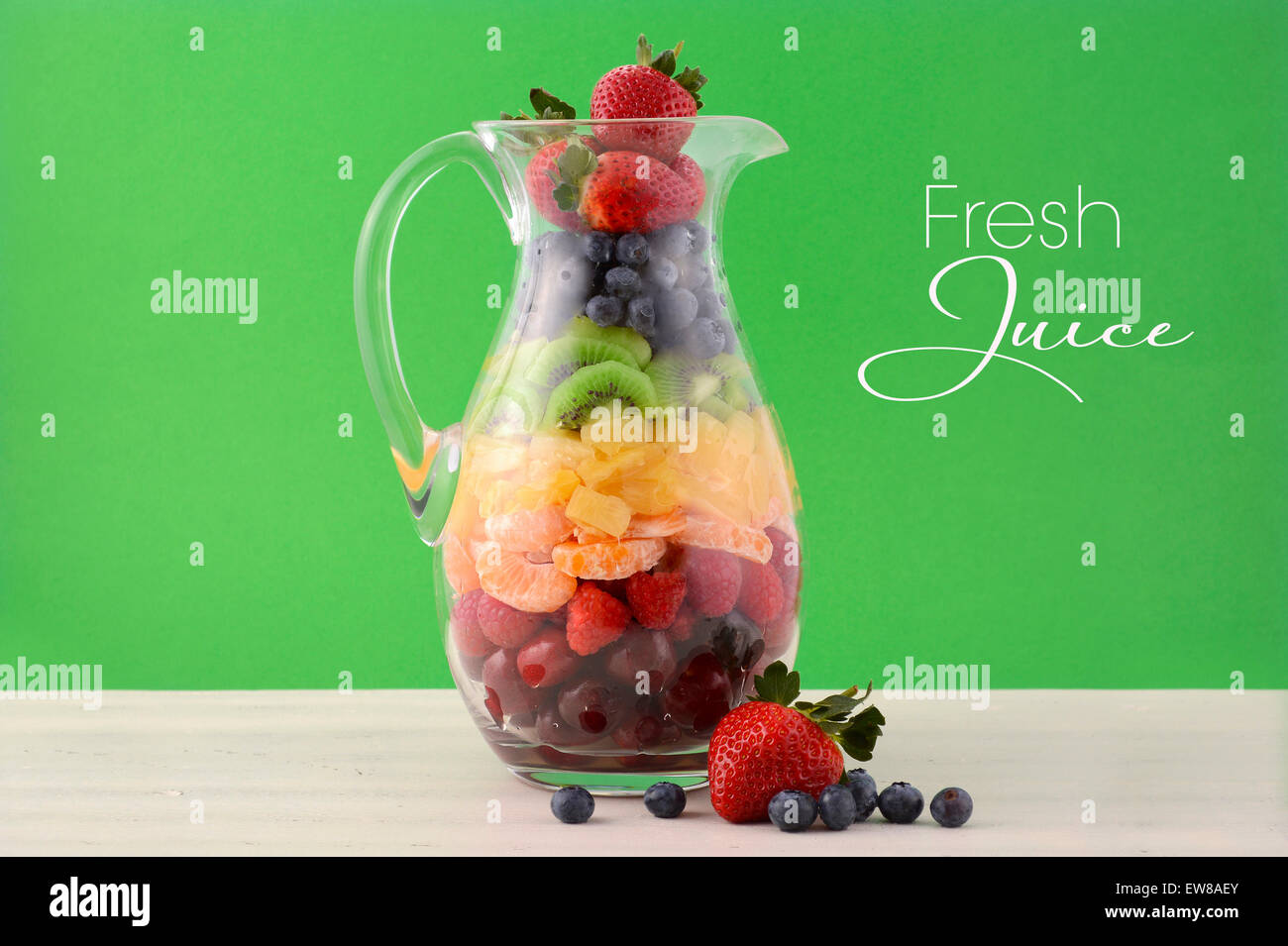 Fresh fruit juice concept with rainbow color fruit including cherries ...