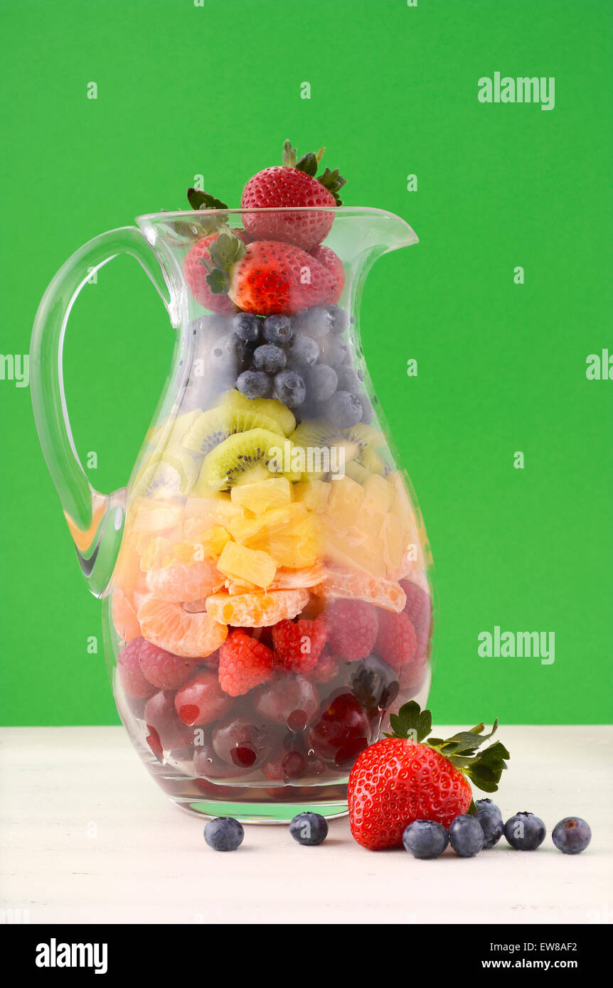 Fresh fruit juice concept with rainbow color fruit including cherries ...
