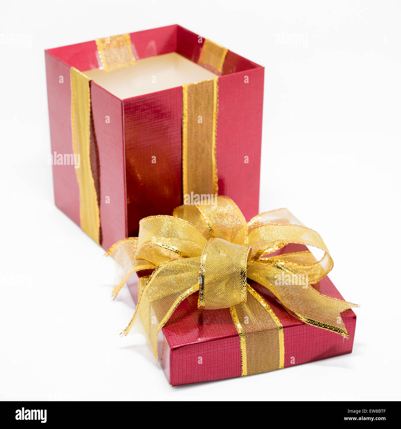 Red gift box with gold ribbon isolated on white Stock Photo - Alamy