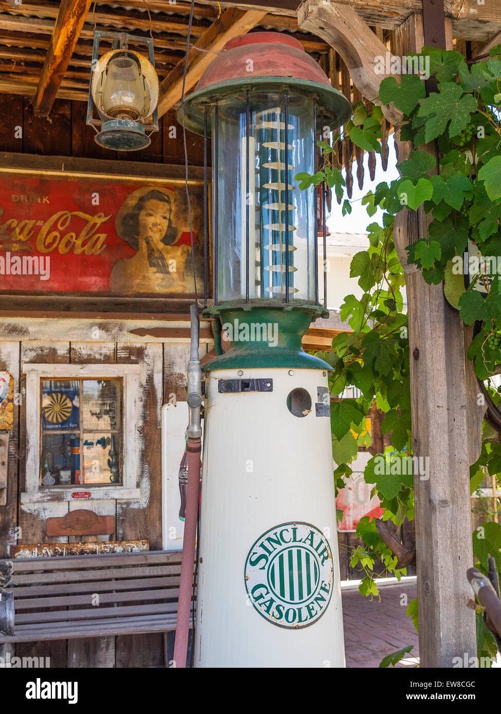 Antique Sinclair gasoline pump in front of a old fashioned gasoline ...