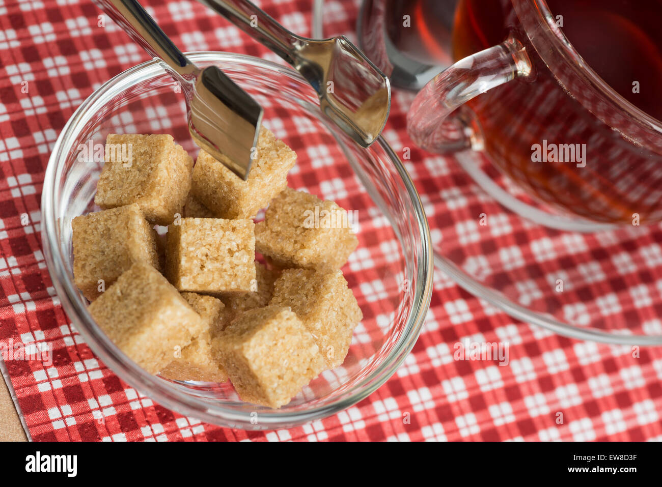 brown cane sugar and a cup of tea on the table Stock Photo - Alamy