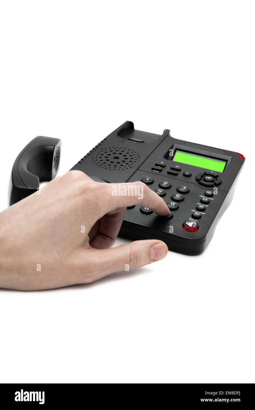 Men's hand dials the number on the black phone isolated on white ...