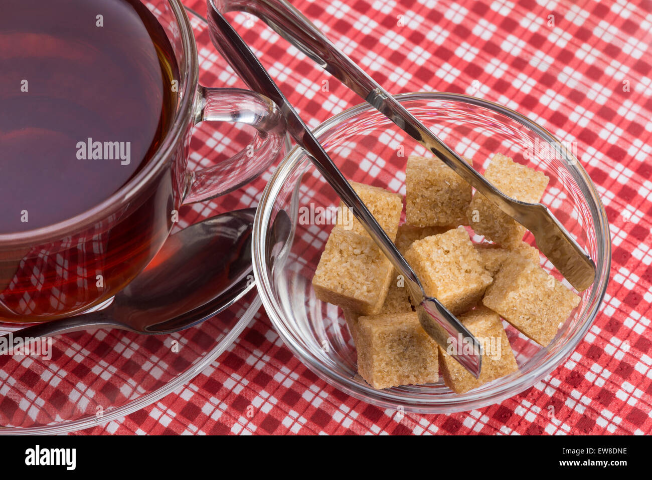 brown cane sugar and a cup of tea on the table Stock Photo - Alamy