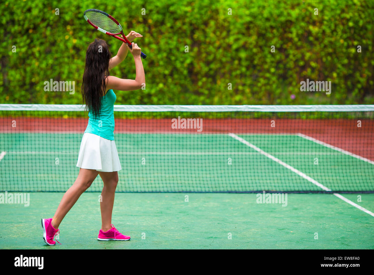 Young active woman playing tennis on tropical vacation Stock Photo - Alamy