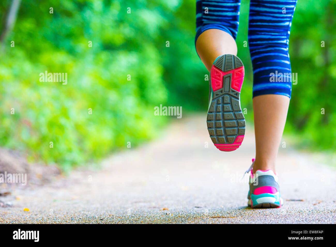 Close-up on shoe of athlete runner woman feet running on road Stock ...