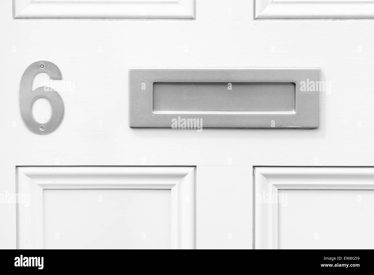 Door number 6 six and letterbox monochrome conceptual image closeup ...