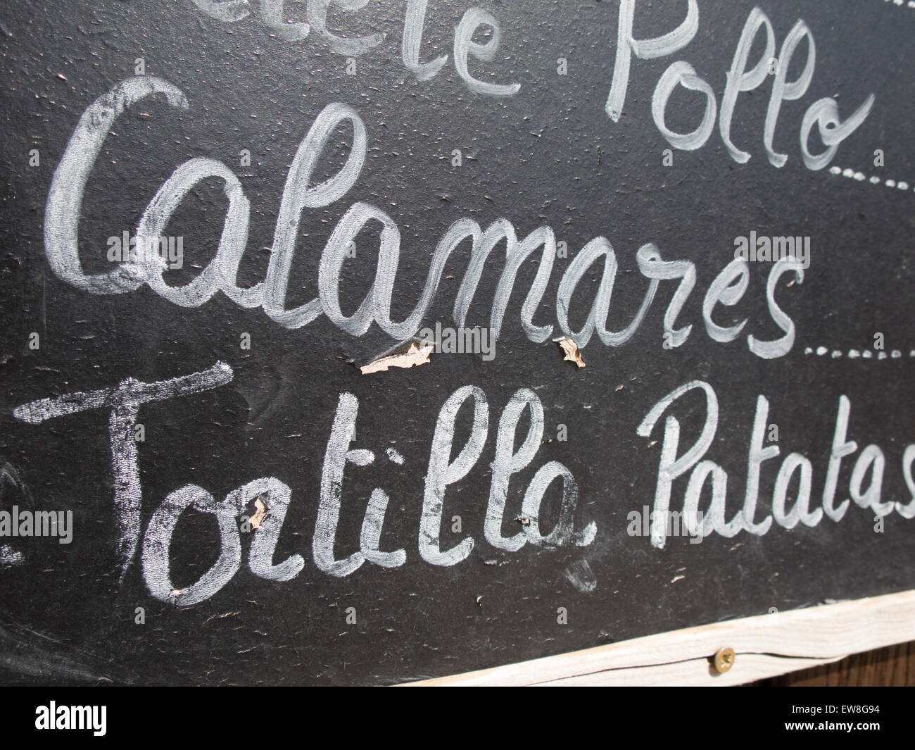 black placard spanish white handwritten in wall with typical menu food ...