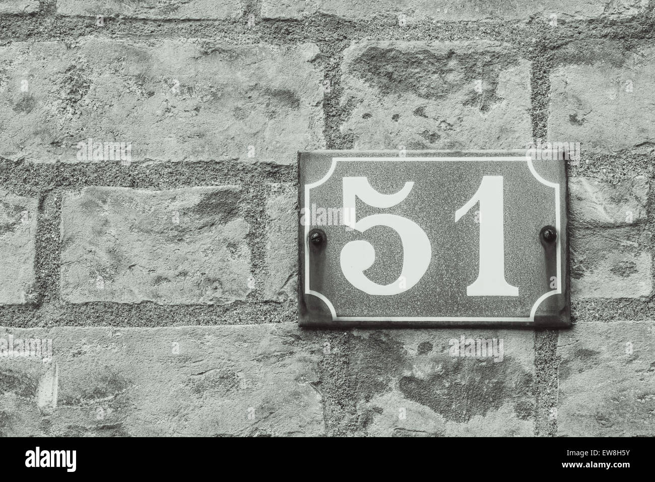 Monochrome House number 51 fifty one on a brick wall conceptual image ...