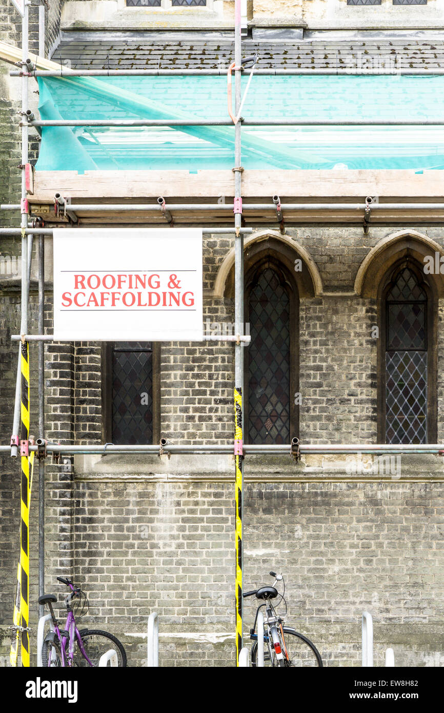 Roofing and Scaffolding sign for repairs of an old building closeup ...