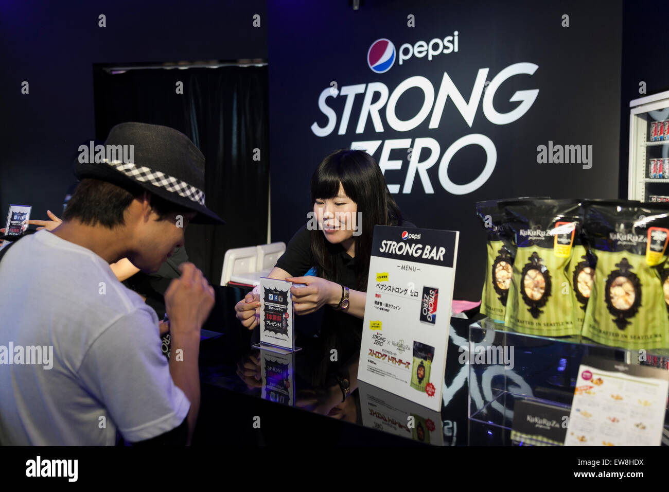 A member of staff shows to customer how to get free a new Pepsi Strong ...