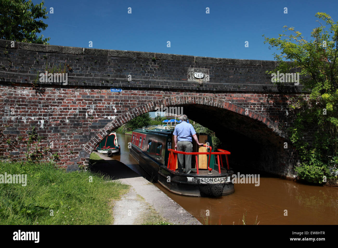 A narrowboat on the Trent & Mersey Canal next to the Broughton Arms pub ...
