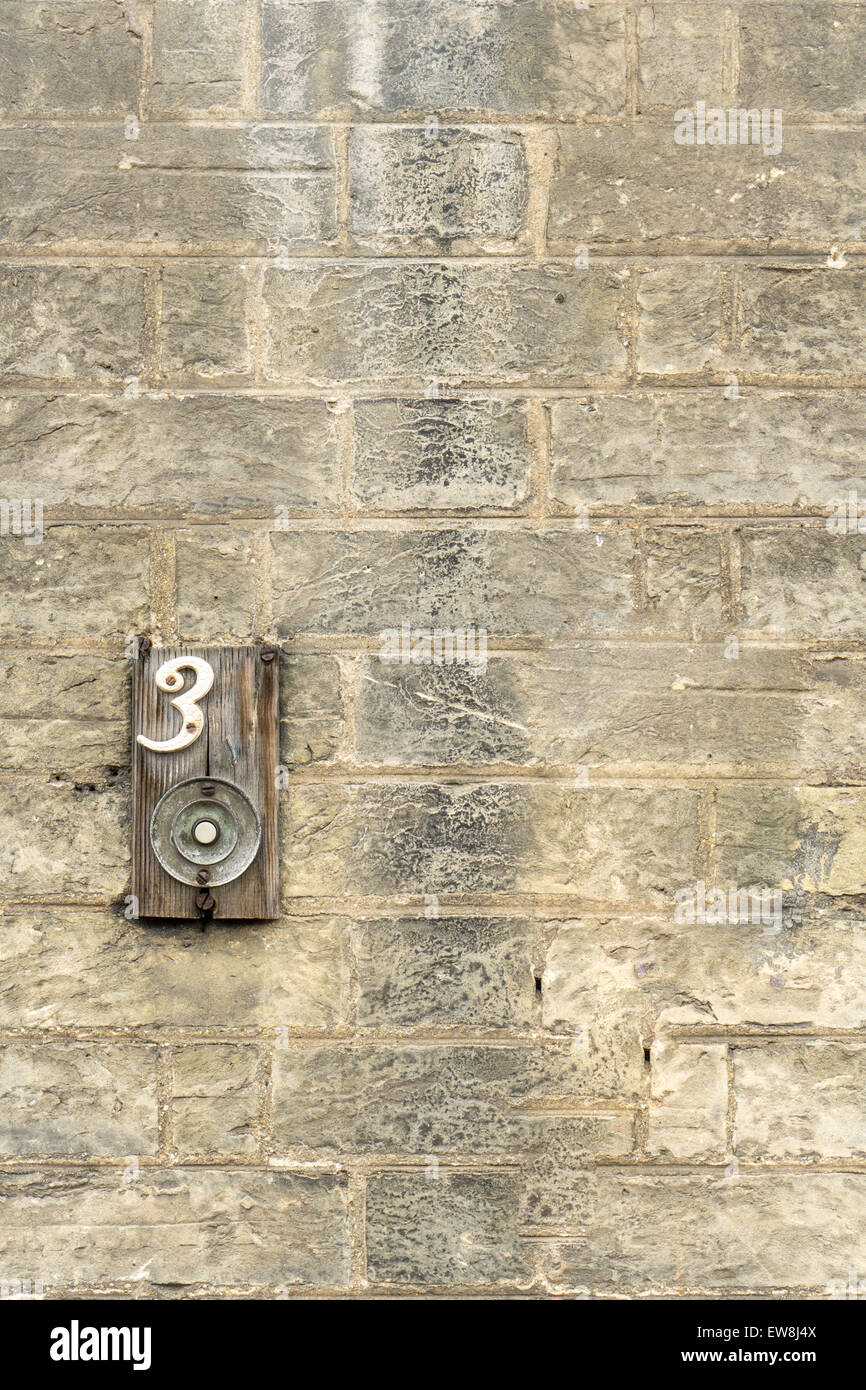 House number 3 three one and door bell on brick wall conceptual image ...