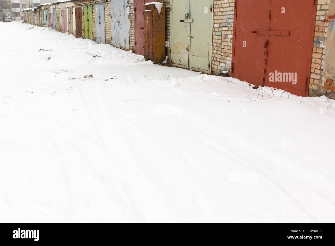 long row of brick garage with metal gates of different colors Stock ...