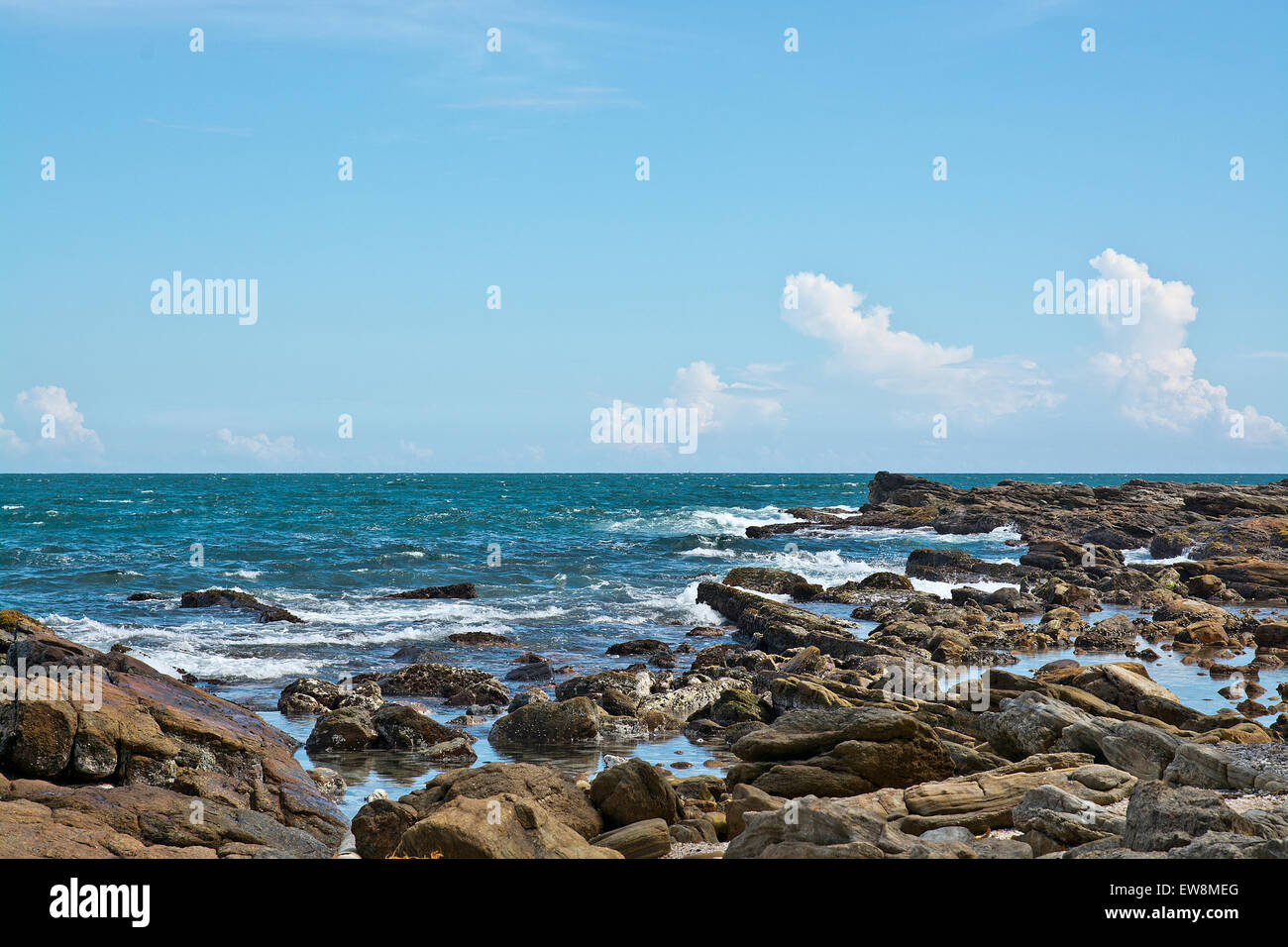 Rocky coast landscape with metamorphic rocks and splashing foaming ...