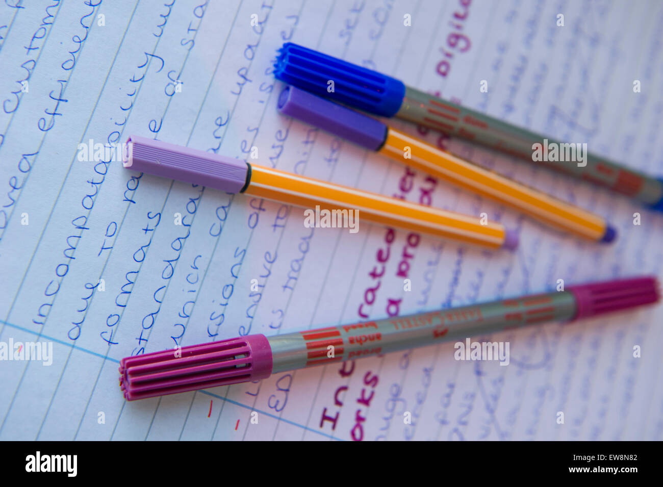 Highlighter pens on A level homework and revision Stock Photo - Alamy