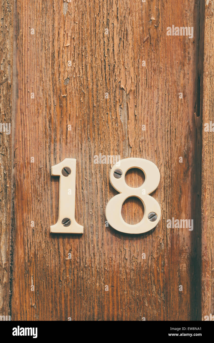 Weathered 18 eighteen sign closeup Stock Photo - Alamy