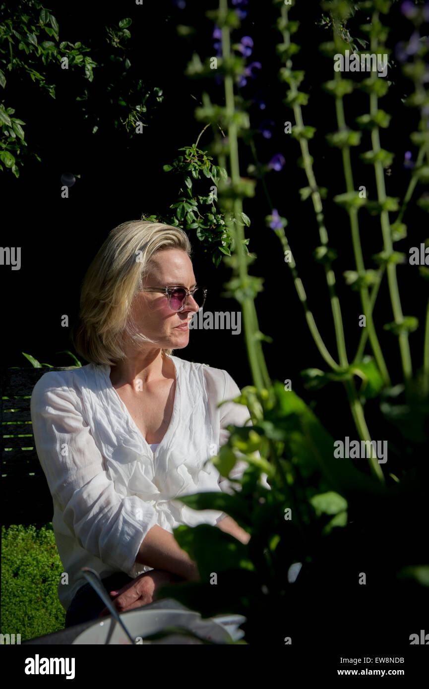 A woman drinking tea in the garden Stock Photo - Alamy