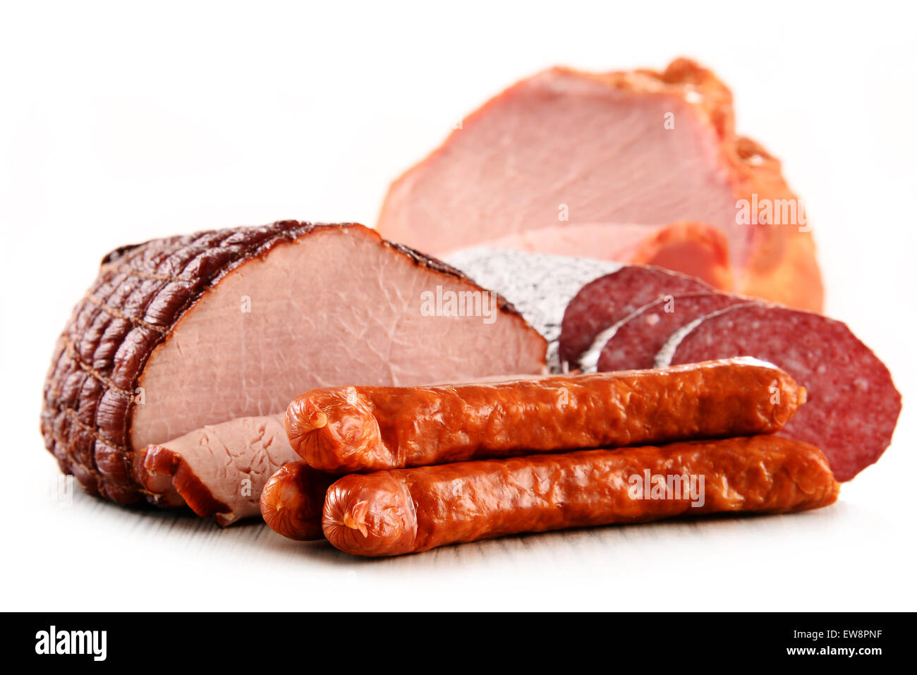 Assorted meat products including ham and sausages isolated on white ...