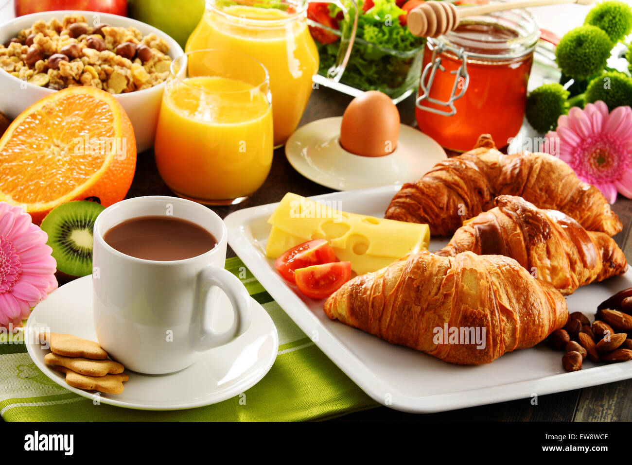 Breakfast consisting of fruits, orange juice, coffee, honey, bread and ...