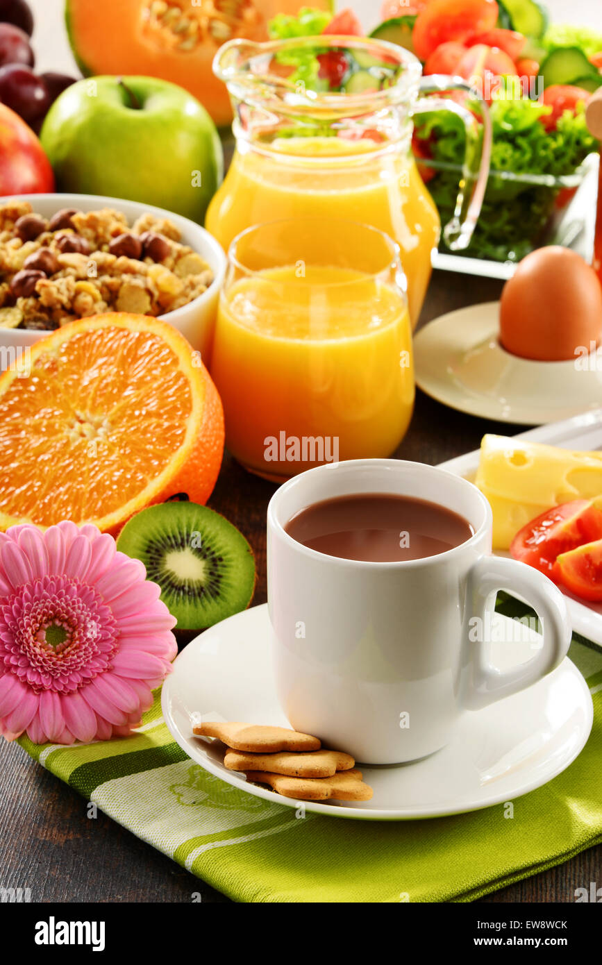Breakfast consisting of fruits, orange juice, coffee, honey, bread and ...