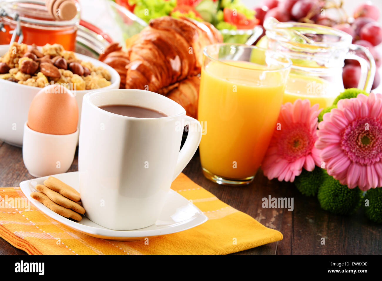 Breakfast consisting of fruits, orange juice, coffee, honey, bread and ...