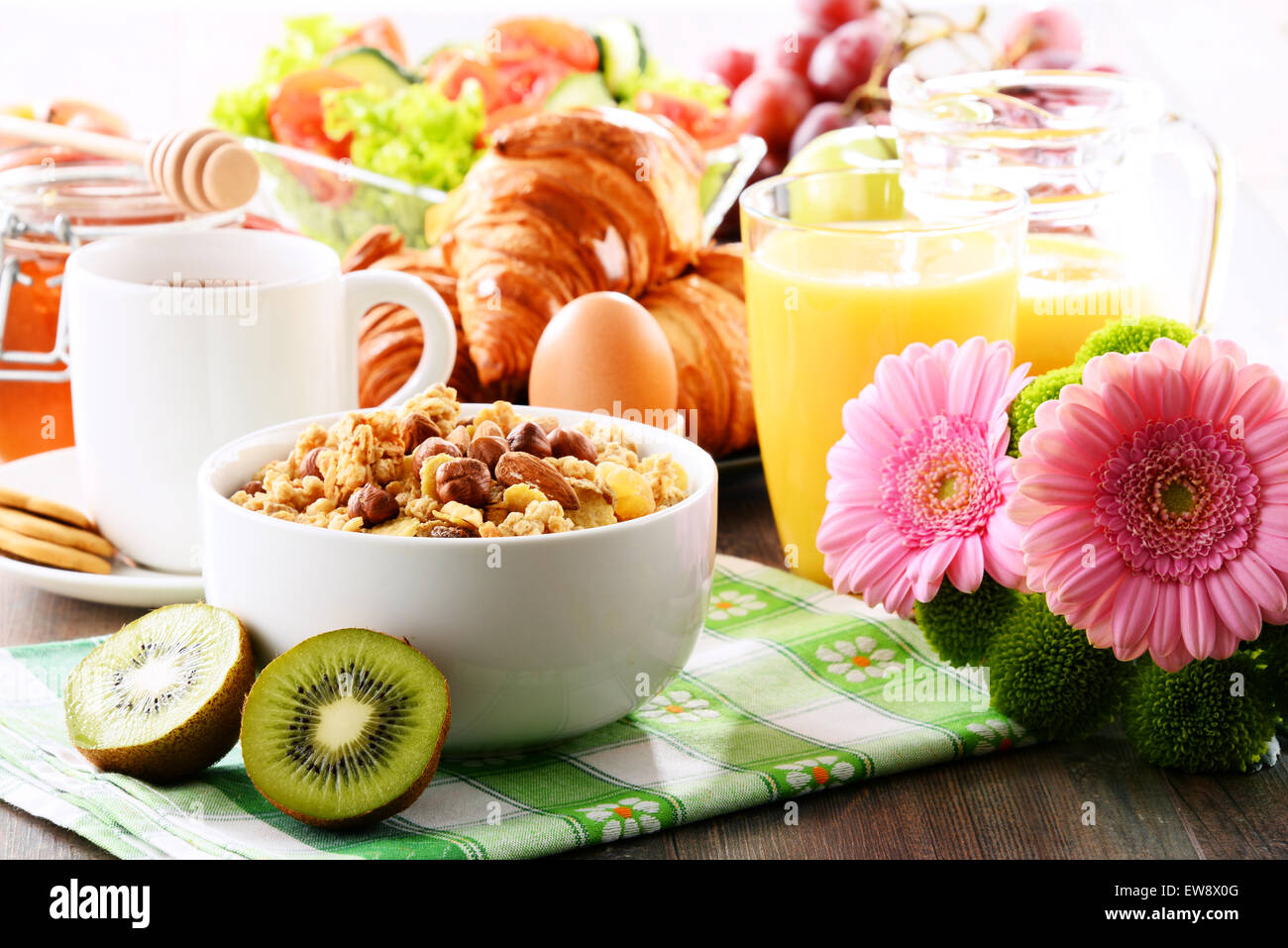 Breakfast consisting of fruits, orange juice, coffee, honey, bread and ...