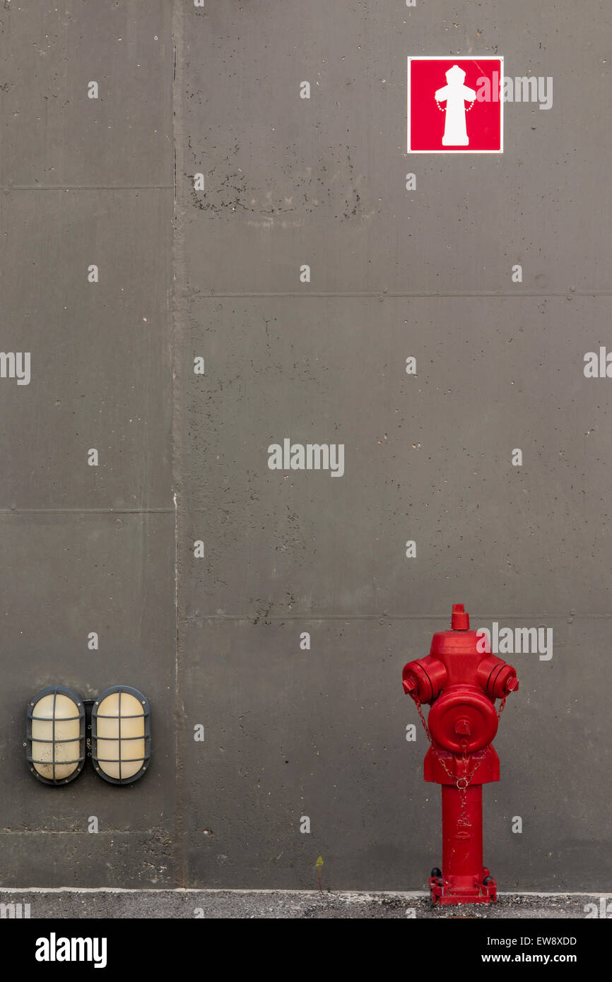 View of a red fire hydrant with warning sign Stock Photo - Alamy