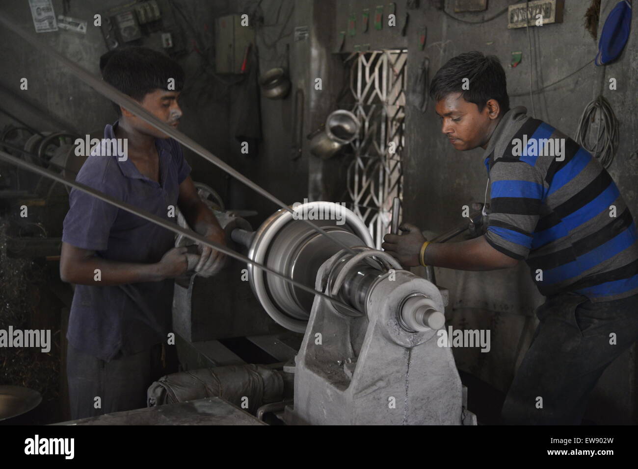 Bangladeshi manual labors works in an aluminum pot-making factory, each ...