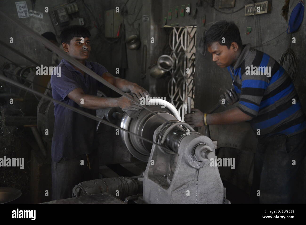 Bangladeshi manual labors works in an aluminum pot-making factory, each ...
