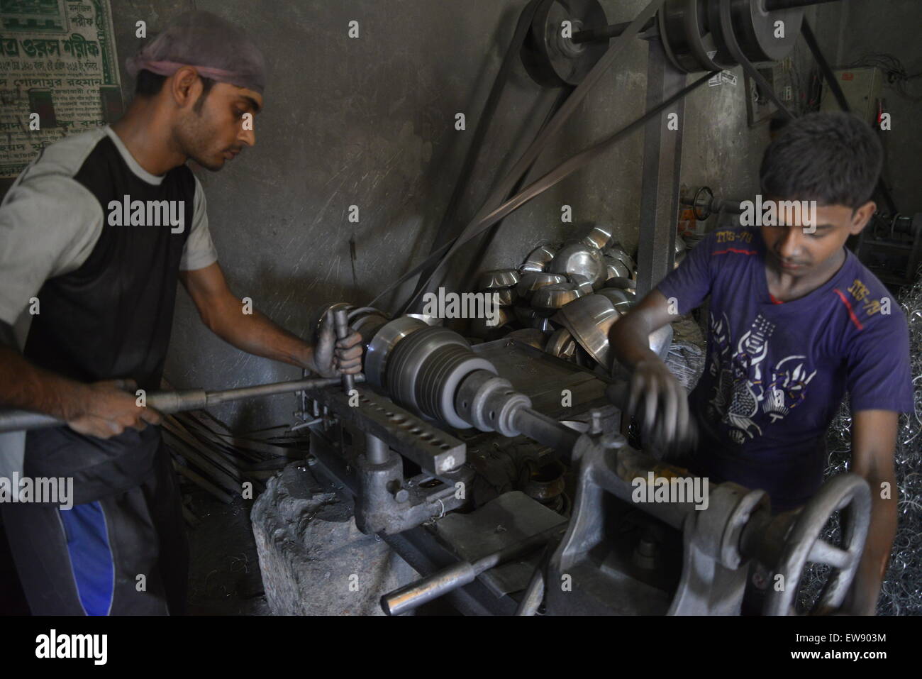 Bangladeshi manual labors works in an aluminum pot-making factory, each ...