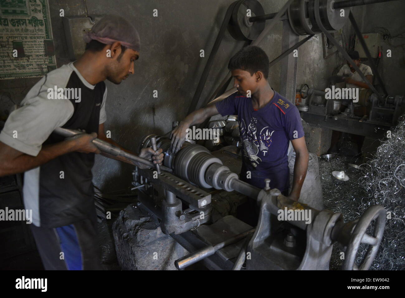 Bangladeshi manual labors works in an aluminum pot-making factory, each ...