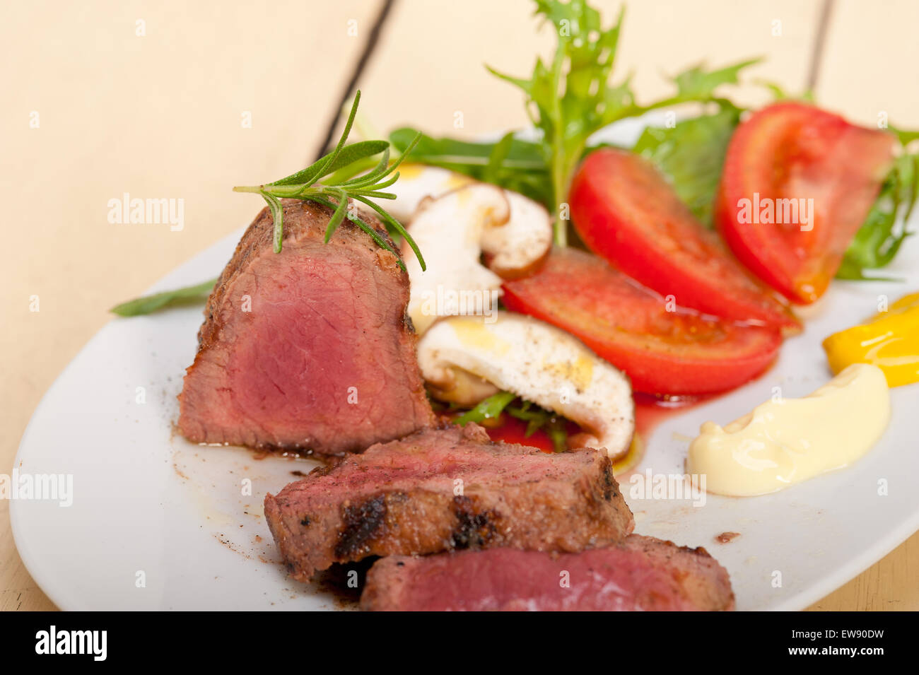 beef filet mignon grilled with fresh vegetables on side ,mushrooms tomato and arugula salad ...