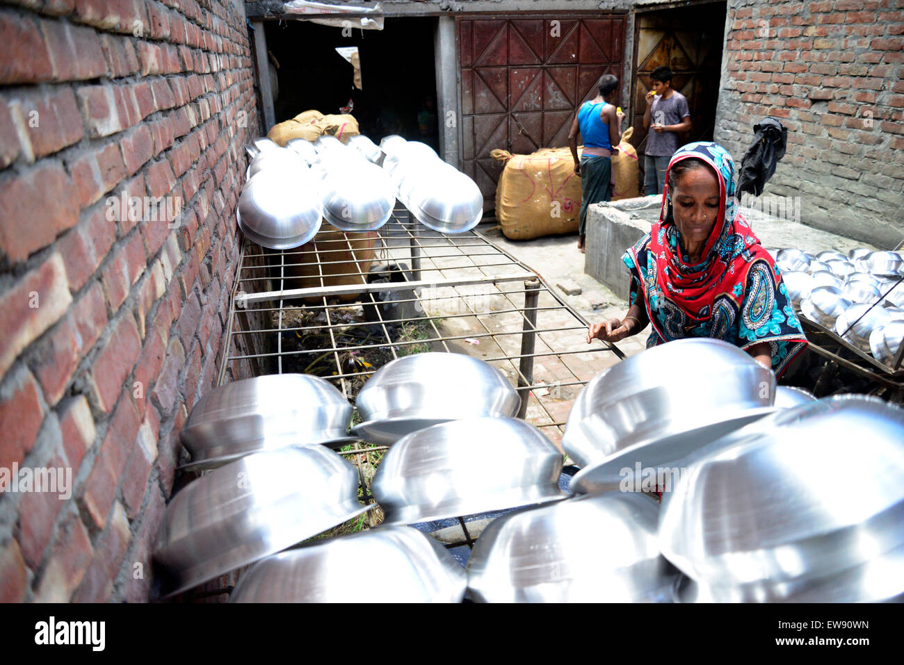 Bangladeshi manual women labors works in an aluminum pot-making factory ...