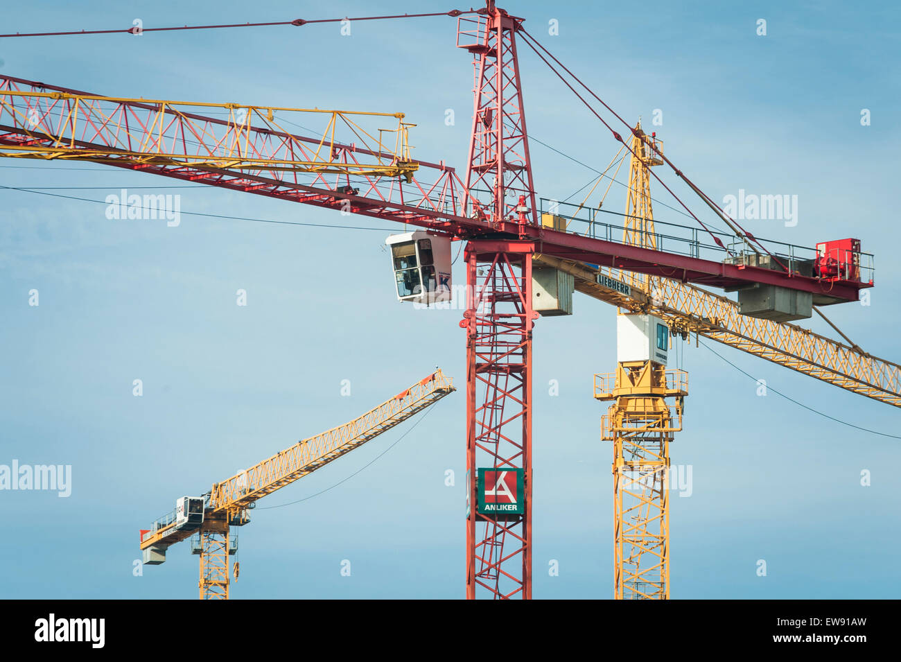 The sky full of building cranes at a large urban construction site in ...