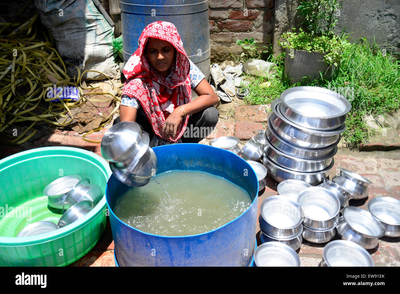 Bangladeshi manual women labors works in an aluminum pot-making factory ...