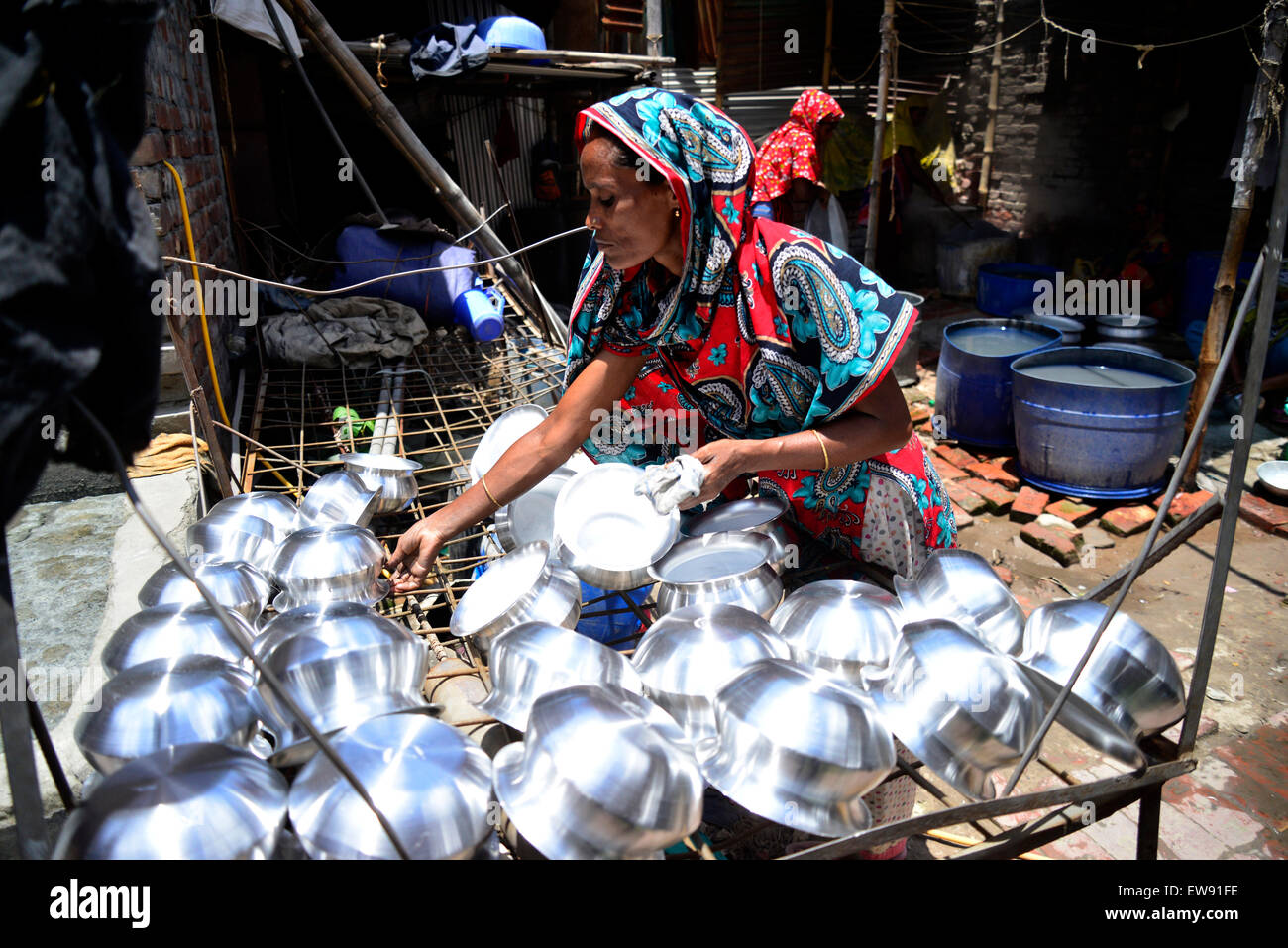 Bangladeshi manual women labors works in an aluminum pot-making factory ...