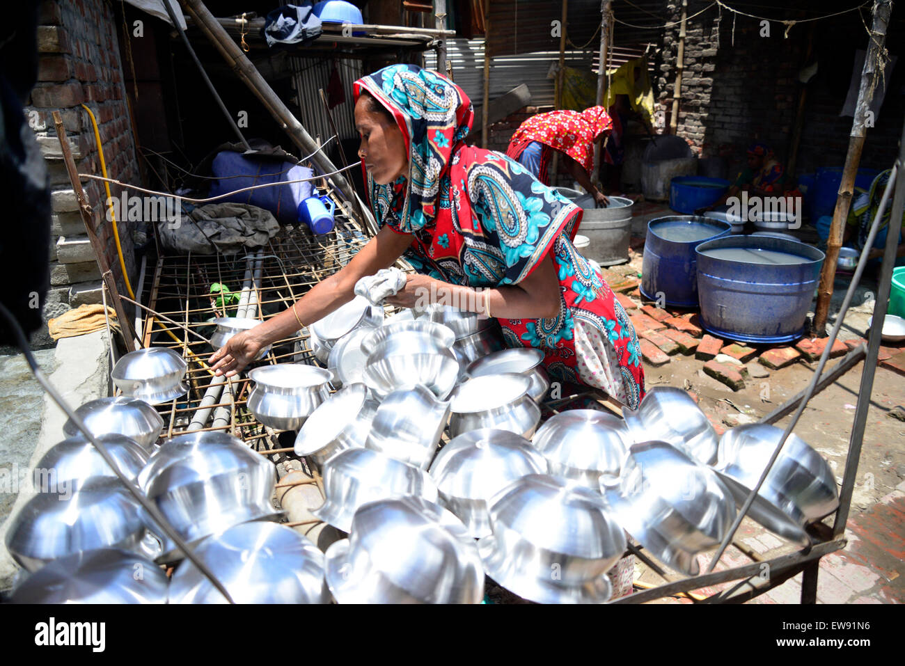 Bangladeshi manual women labors works in an aluminum pot-making factory ...