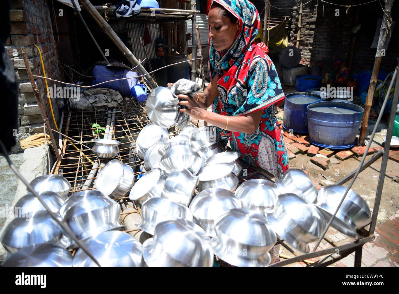 Bangladeshi manual women labors works in an aluminum pot-making factory ...