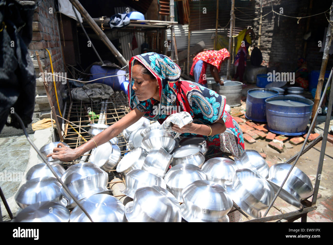 Bangladeshi manual women labors works in an aluminum pot-making factory ...