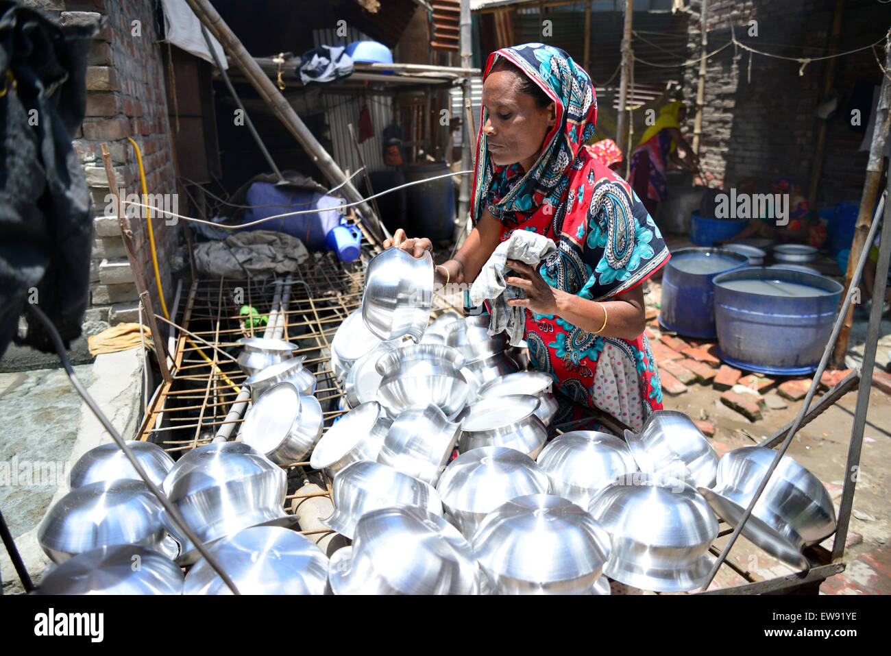 Bangladeshi manual women labors works in an aluminum pot-making factory ...