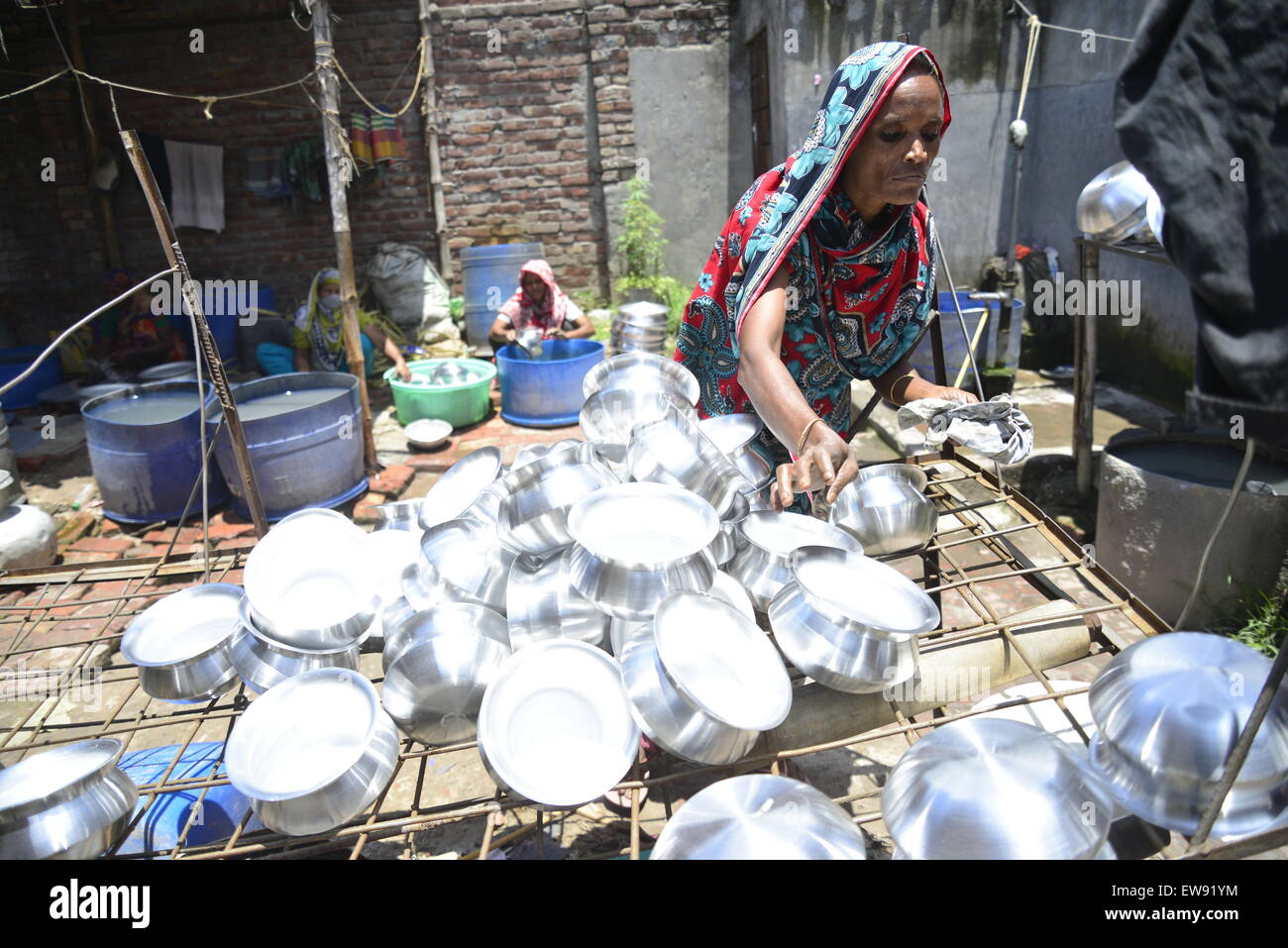 Bangladeshi manual women labors works in an aluminum pot-making factory ...