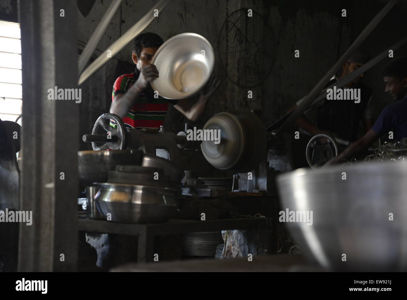 Bangladeshi manual labors works in an aluminum pot-making factory, each ...