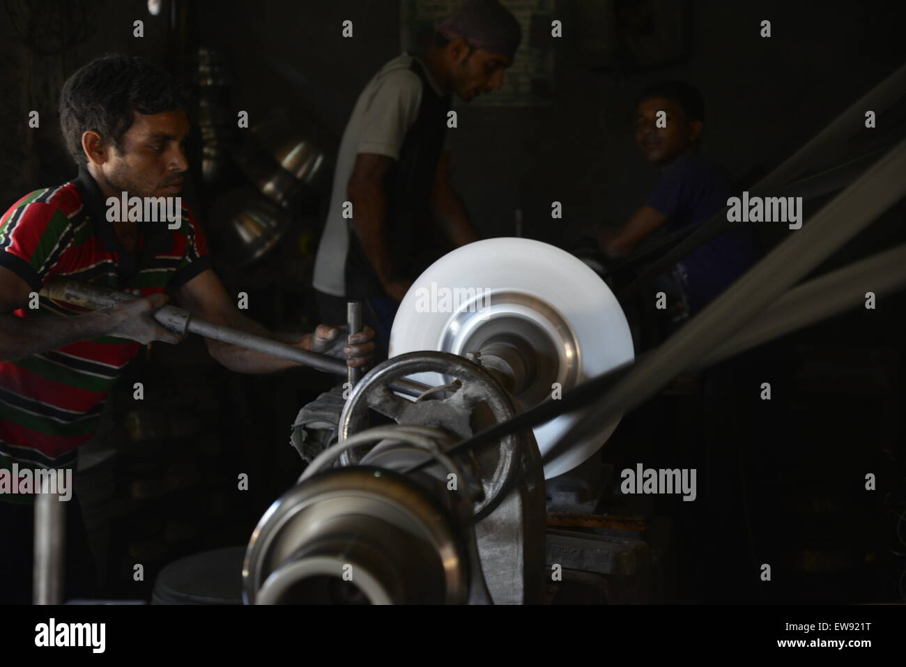 Bangladeshi manual labors works in an aluminum pot-making factory, each ...