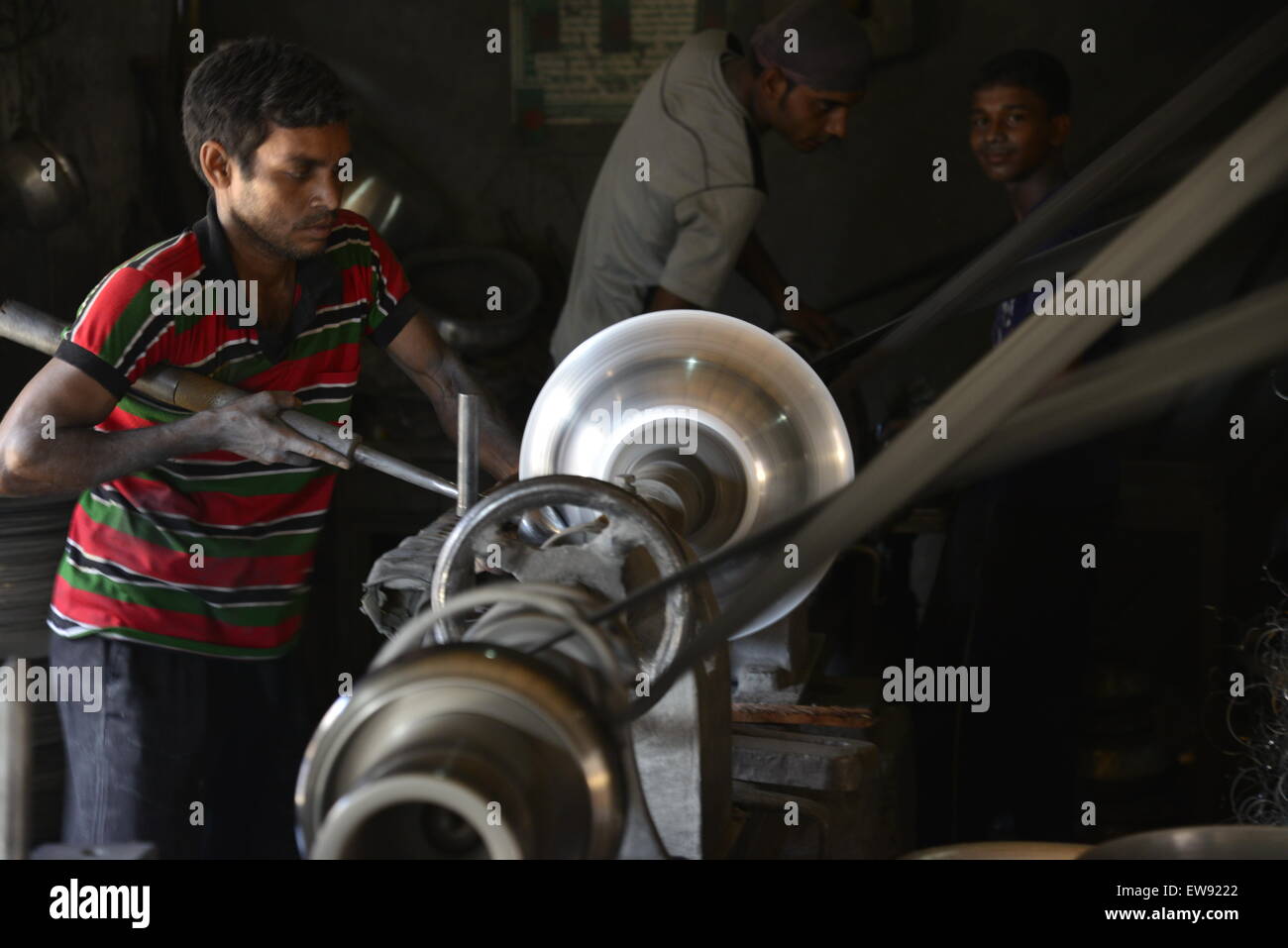 Bangladeshi manual labors works in an aluminum pot-making factory, each ...