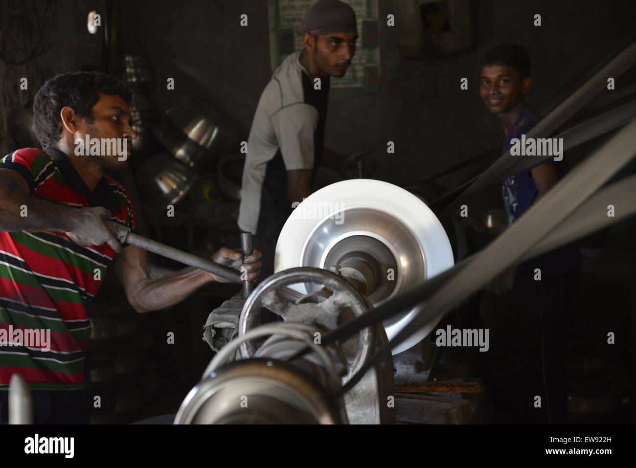 Bangladeshi manual labors works in an aluminum pot-making factory, each ...