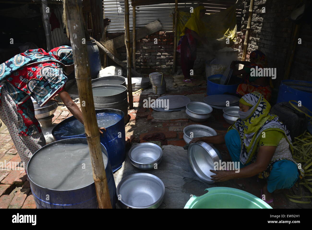 Bangladeshi women labors works in an aluminum pot-making factory, each ...
