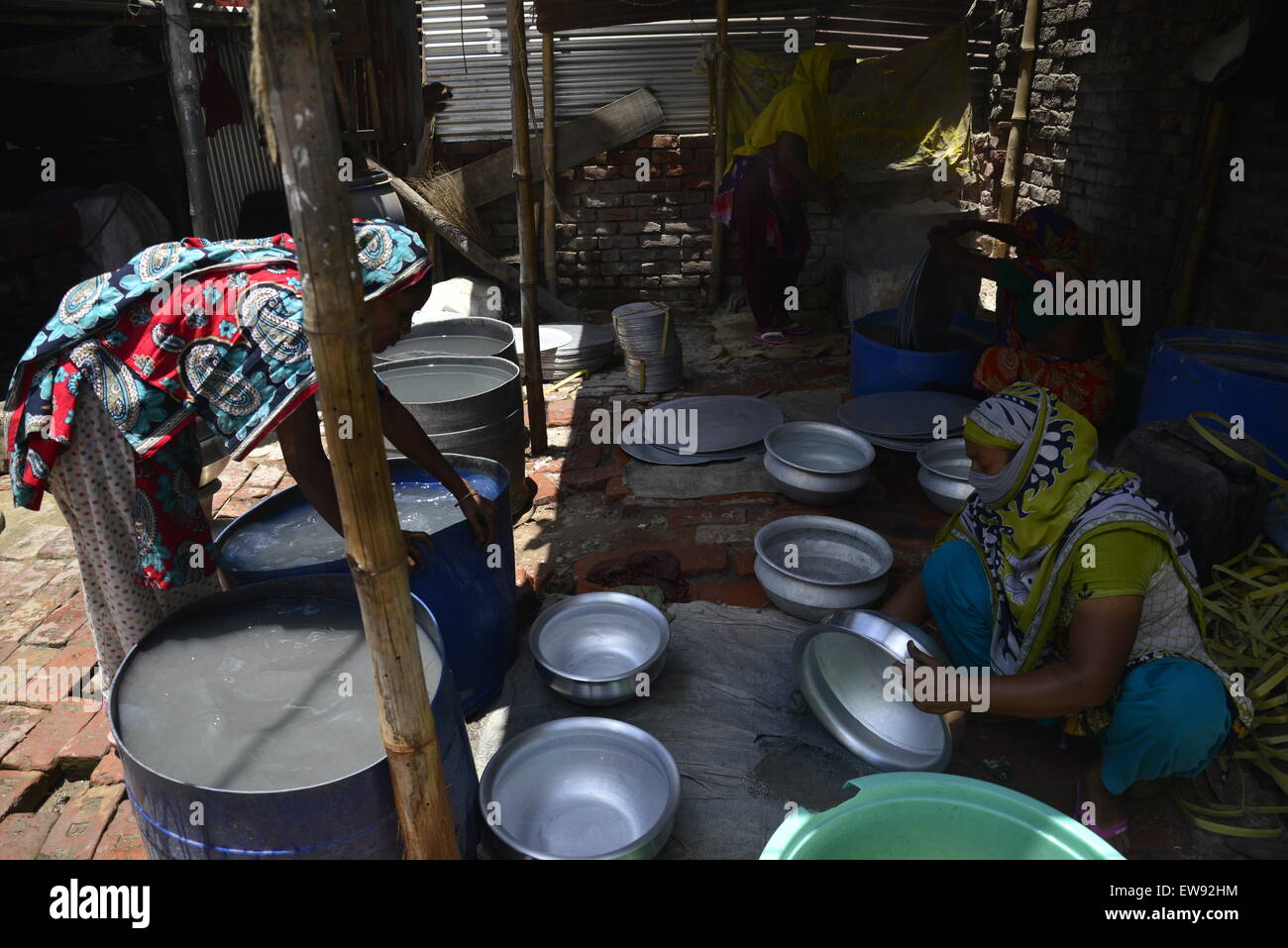 Bangladeshi women labors works in an aluminum pot-making factory, each ...