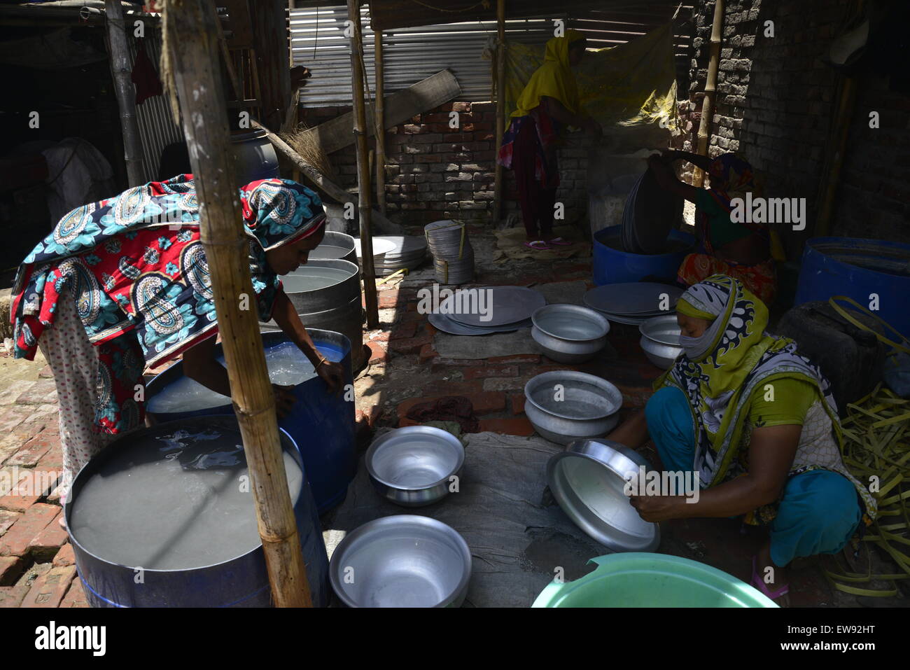 Bangladeshi women labors works in an aluminum pot-making factory, each ...